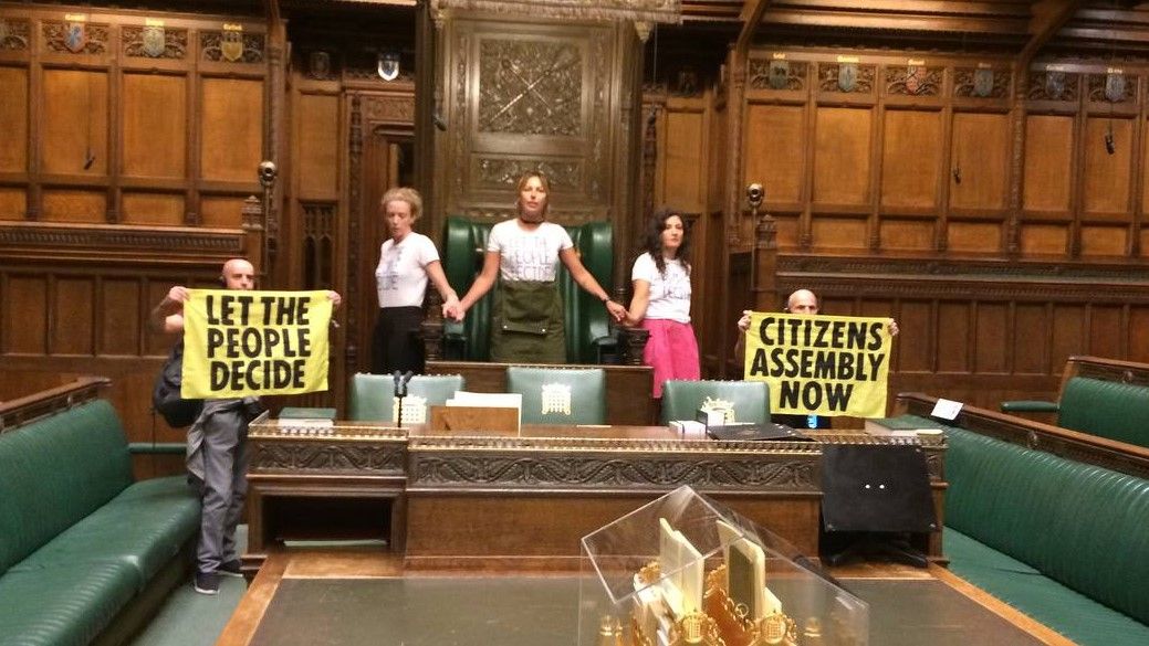 Protestors glue themselves to the Speaker's chair in Parliament