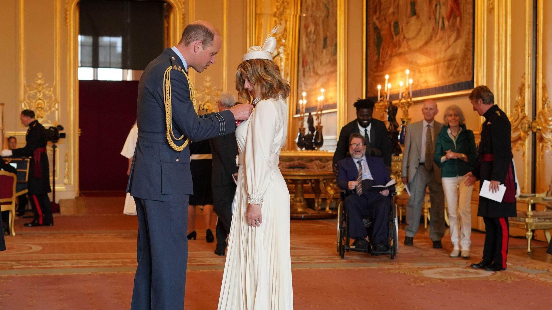 Kate Garroway gets MBE as smiling husband watches on