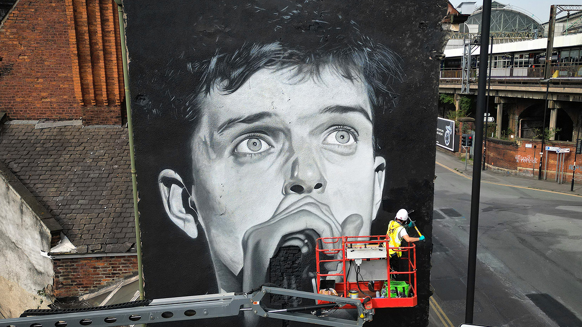 Iconic Ian Curtis mural recreated at new location in Manchester – photos