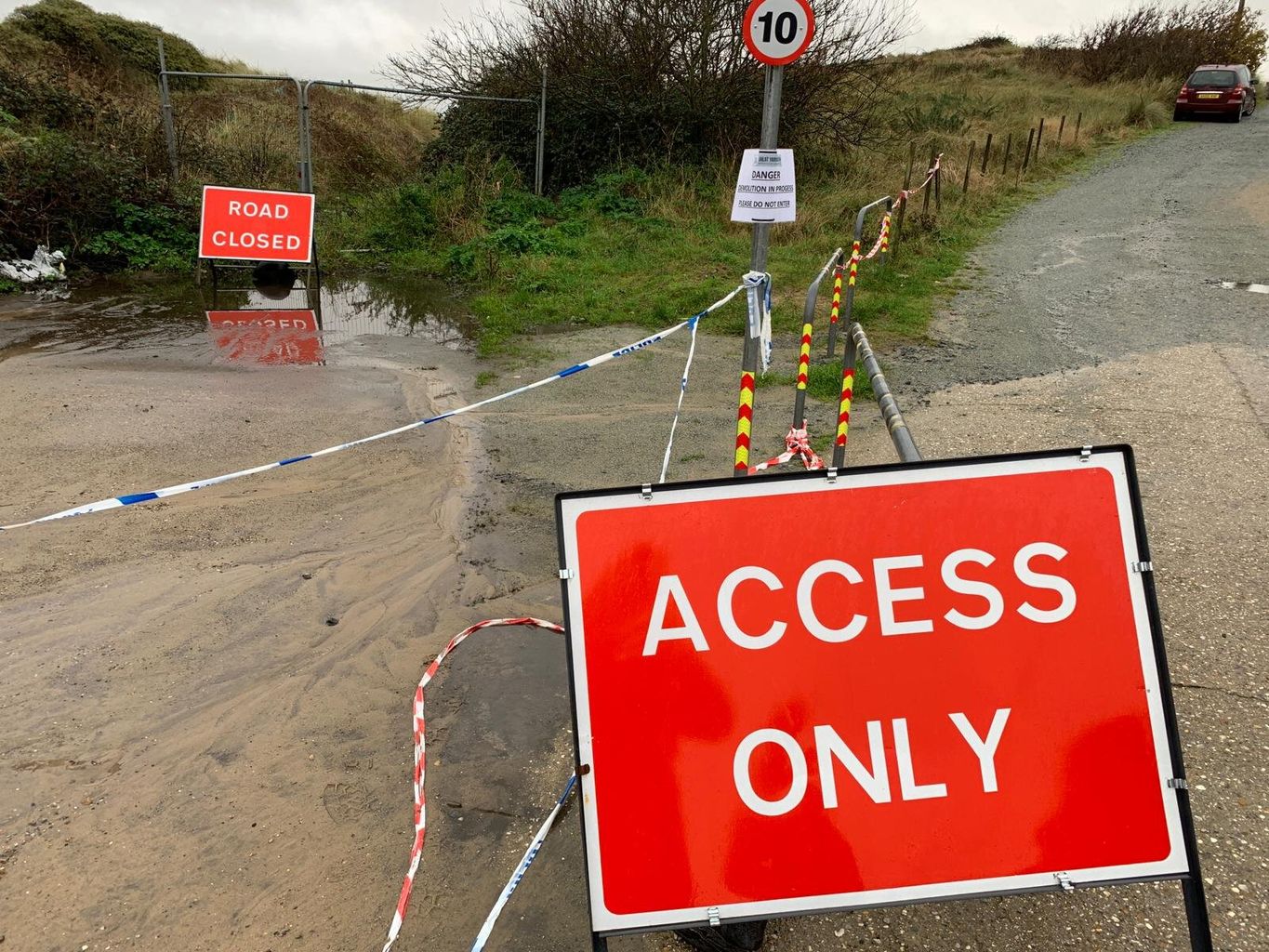 Demolition work begins on five clifftop homes in Norfolk village hit by ...
