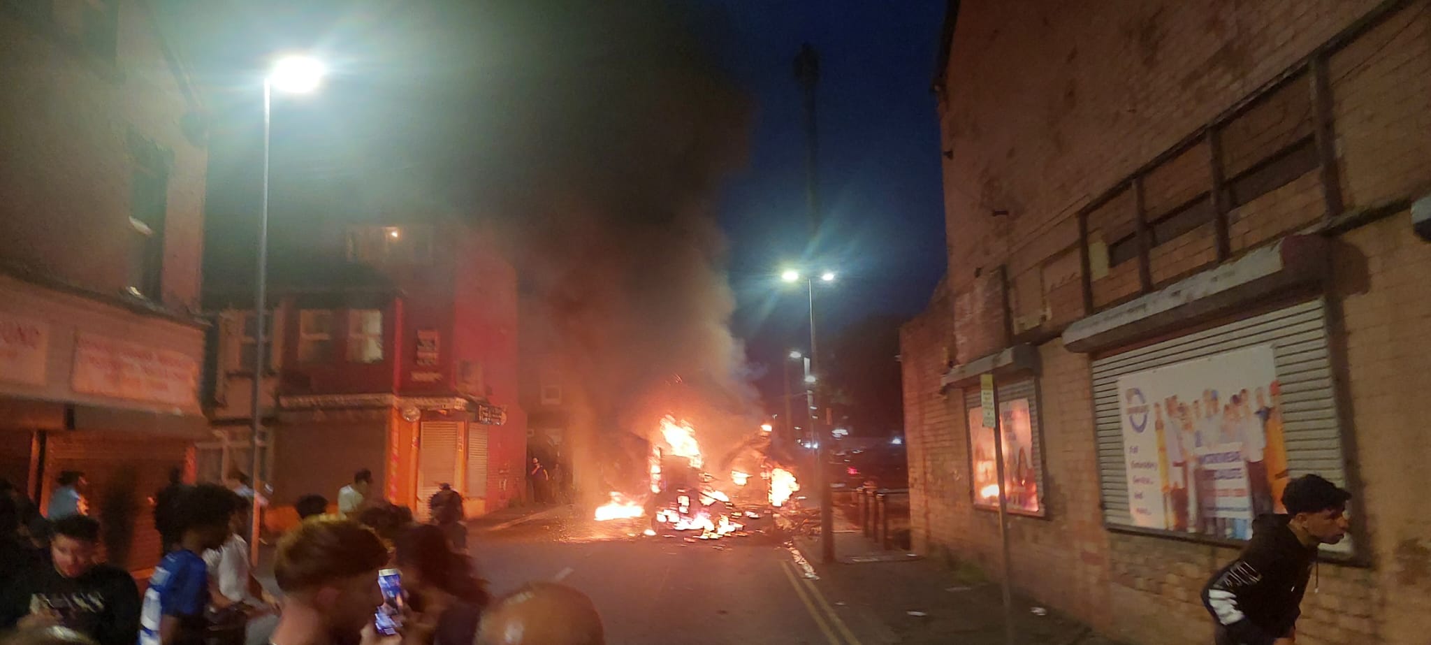 Police car tipped and fire started as huge crowds gather in Harehills ...