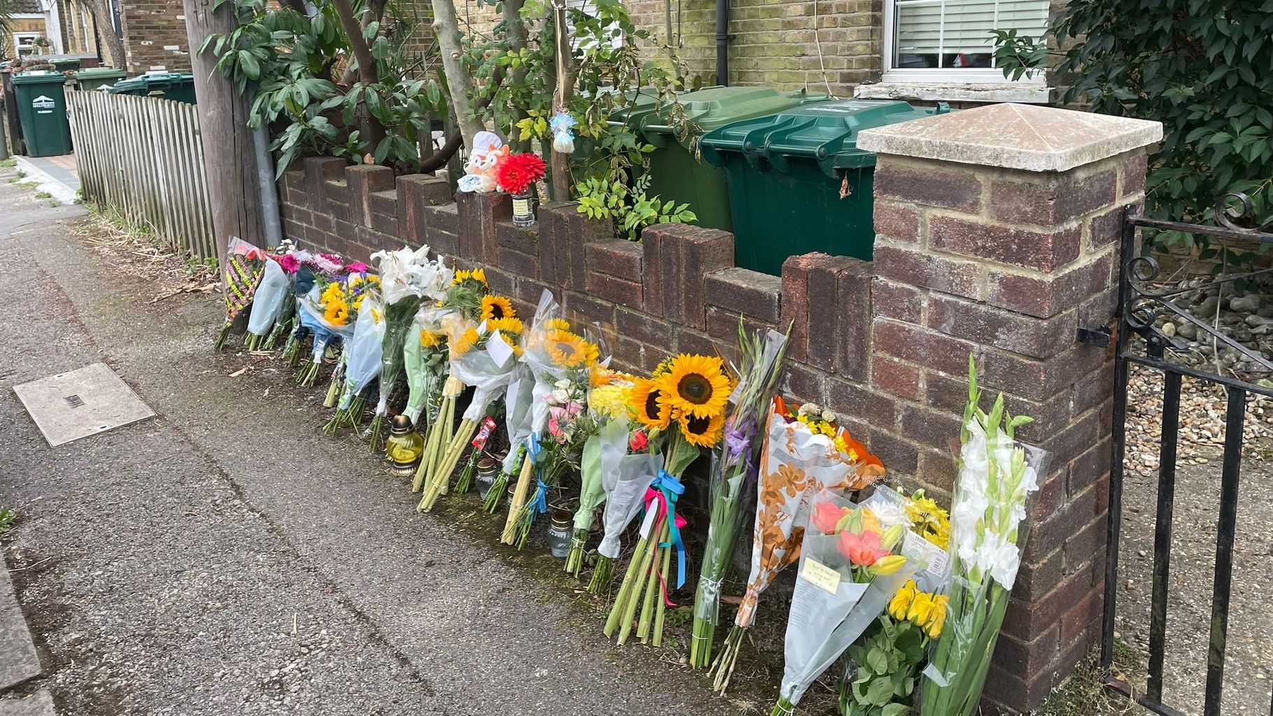 Tributes left after three children and a man found dead in Surrey ...