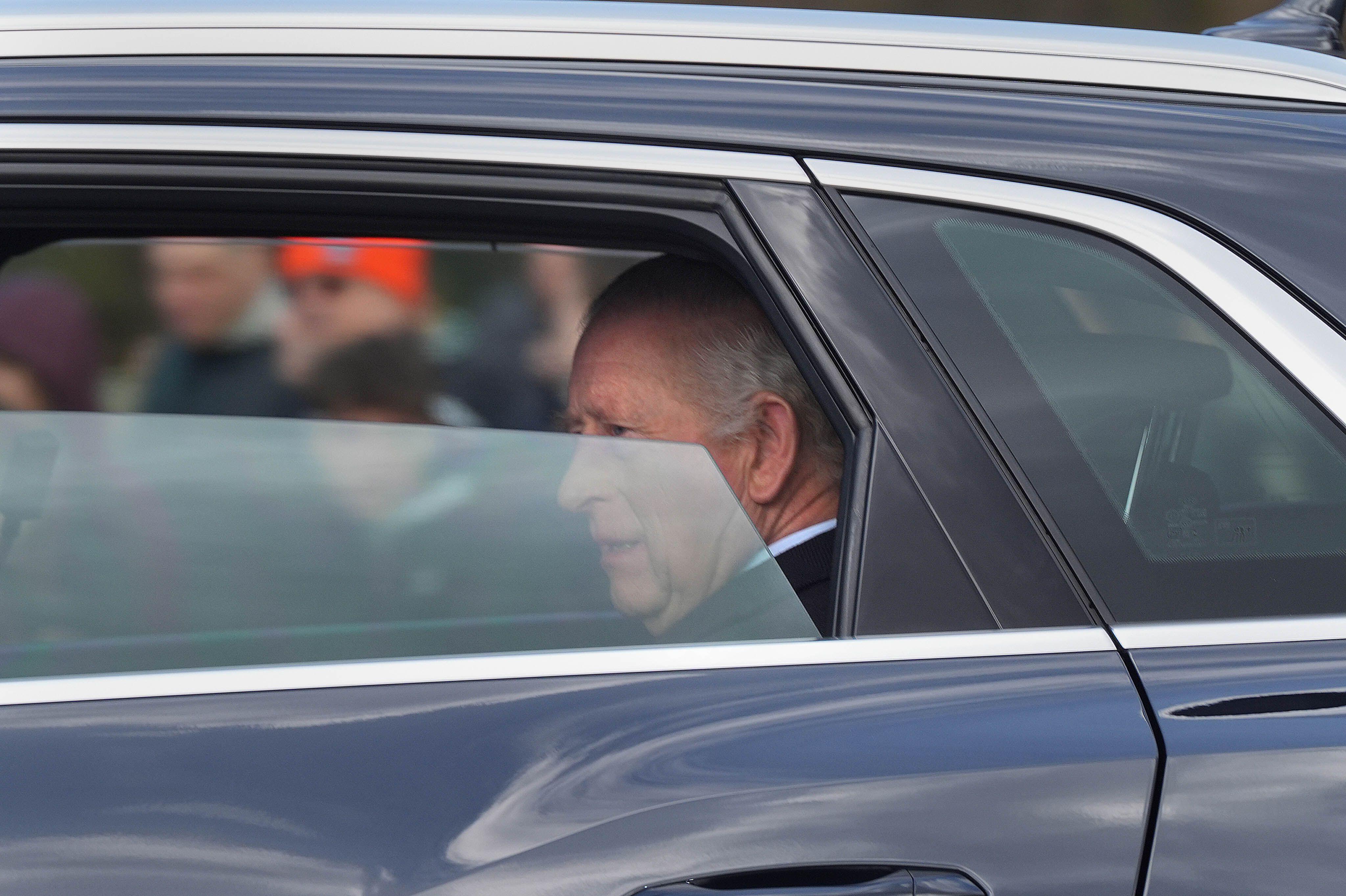 King waves to well-wishers after hospital stay cancels Birmingham visit