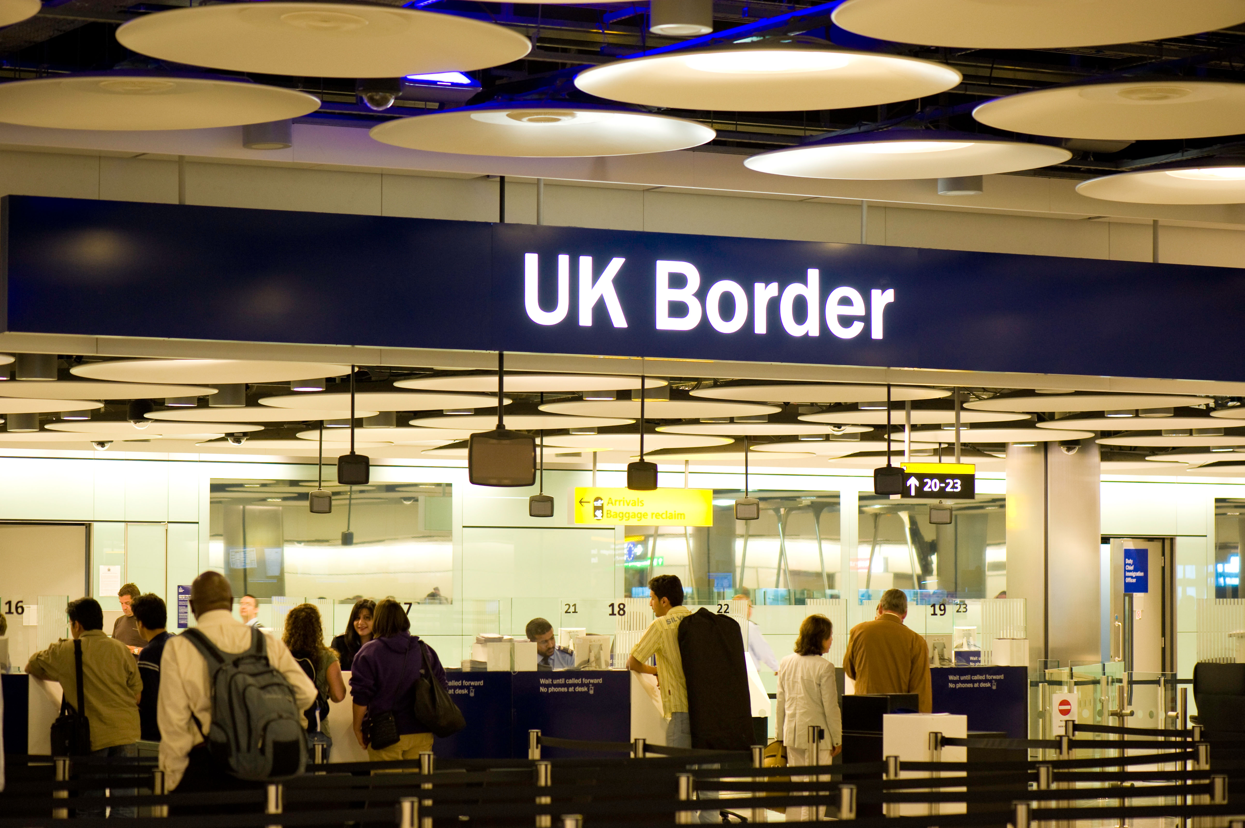 Net migration to the UK halves last year