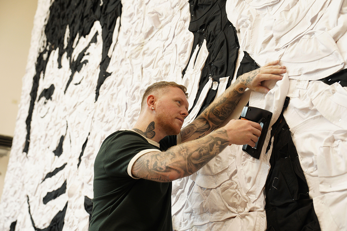 Oasis mural made from 3,000 bucket hats unveiled in Cardiff